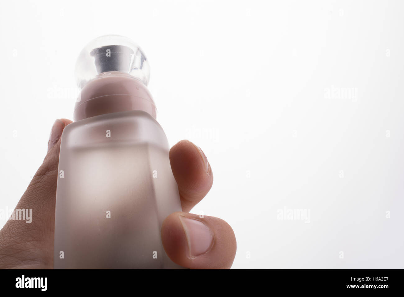 Little perfume glass bottle in hand on a white background Stock Photo ...