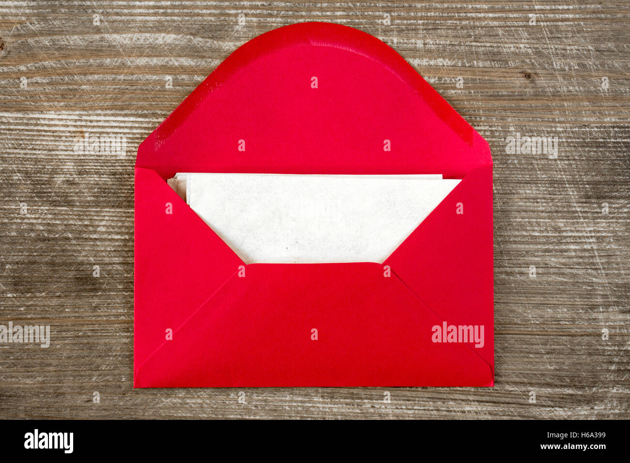Opened red envelope with blank letter on wooden desk Stock Photo - Alamy
