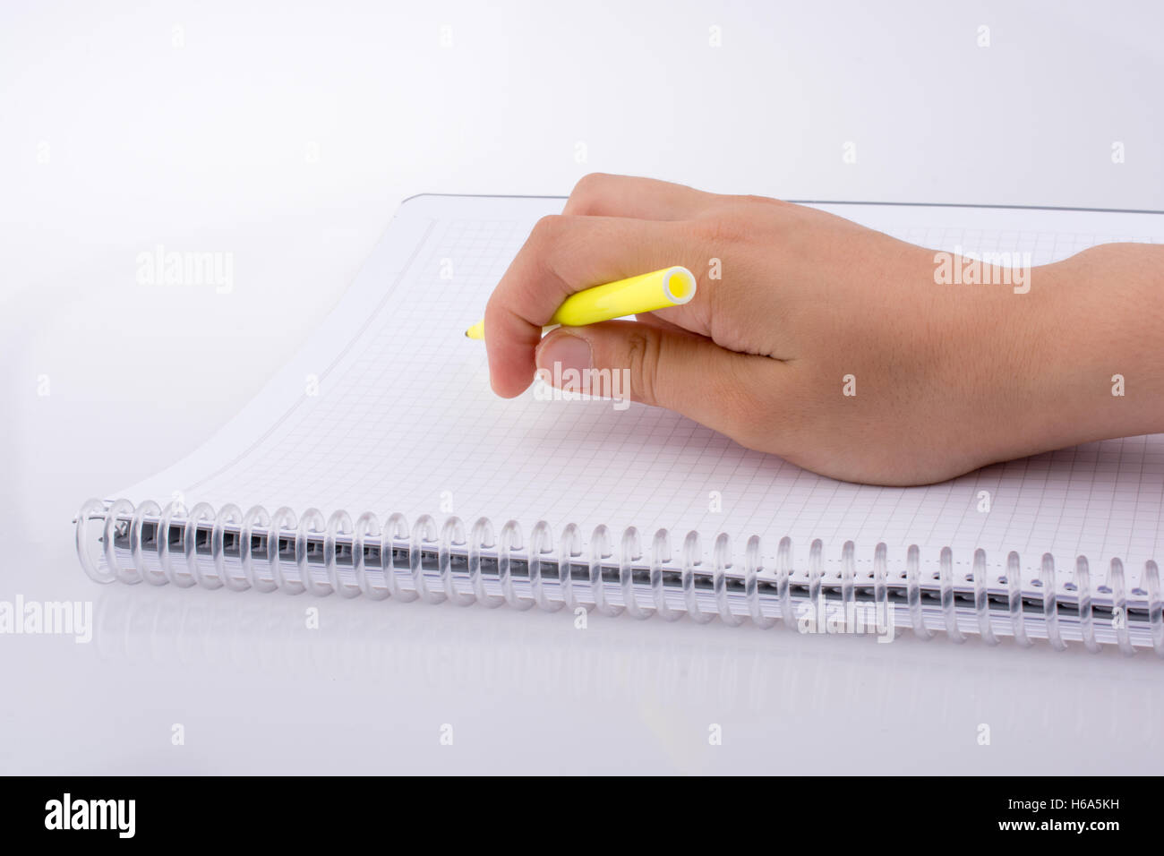 Hand writing on a Notebook with a pen on a white background Stock Photo ...