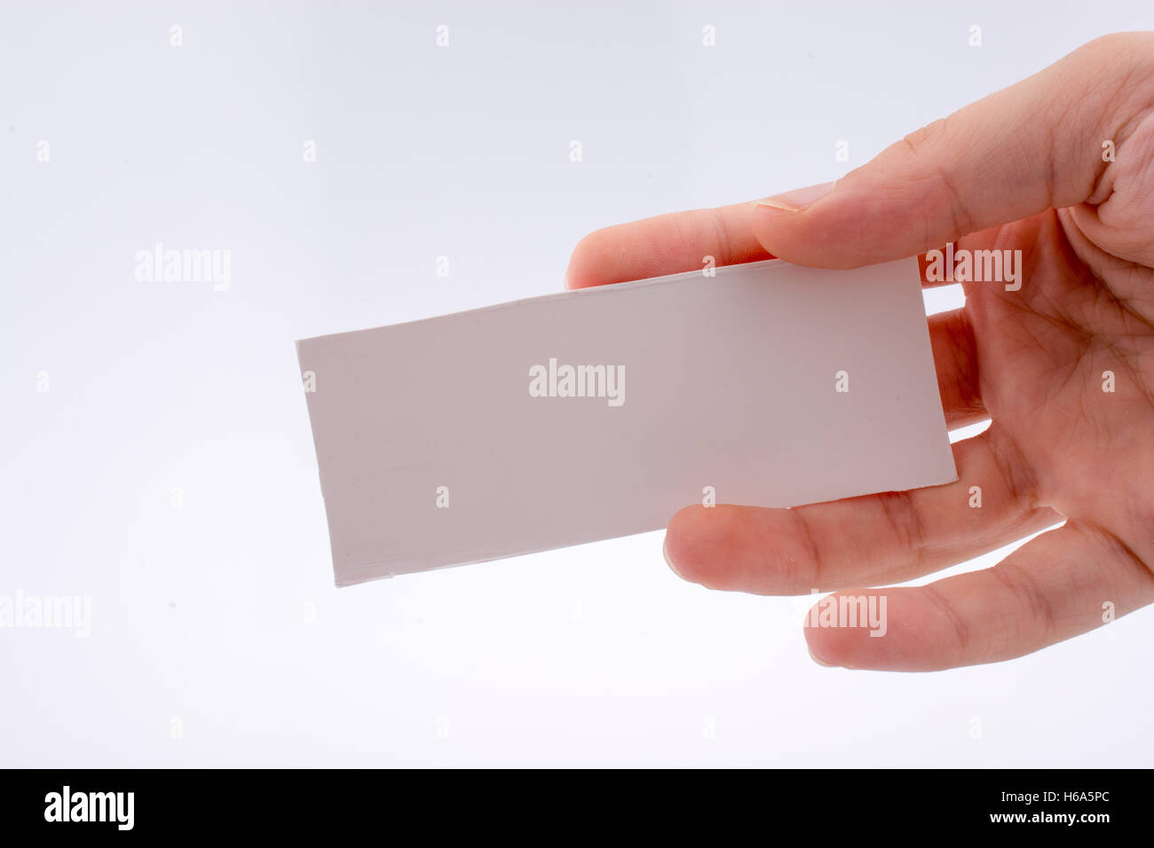 Hand holding a note paper on a white background Stock Photo - Alamy