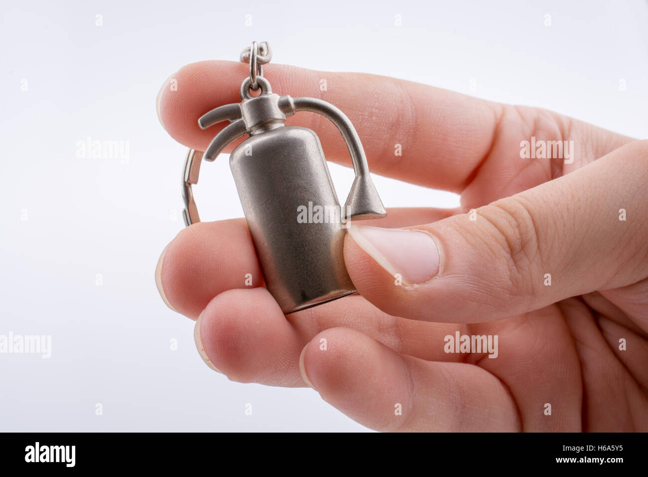 model fire extinguisher key holder in hand Stock Photo - Alamy