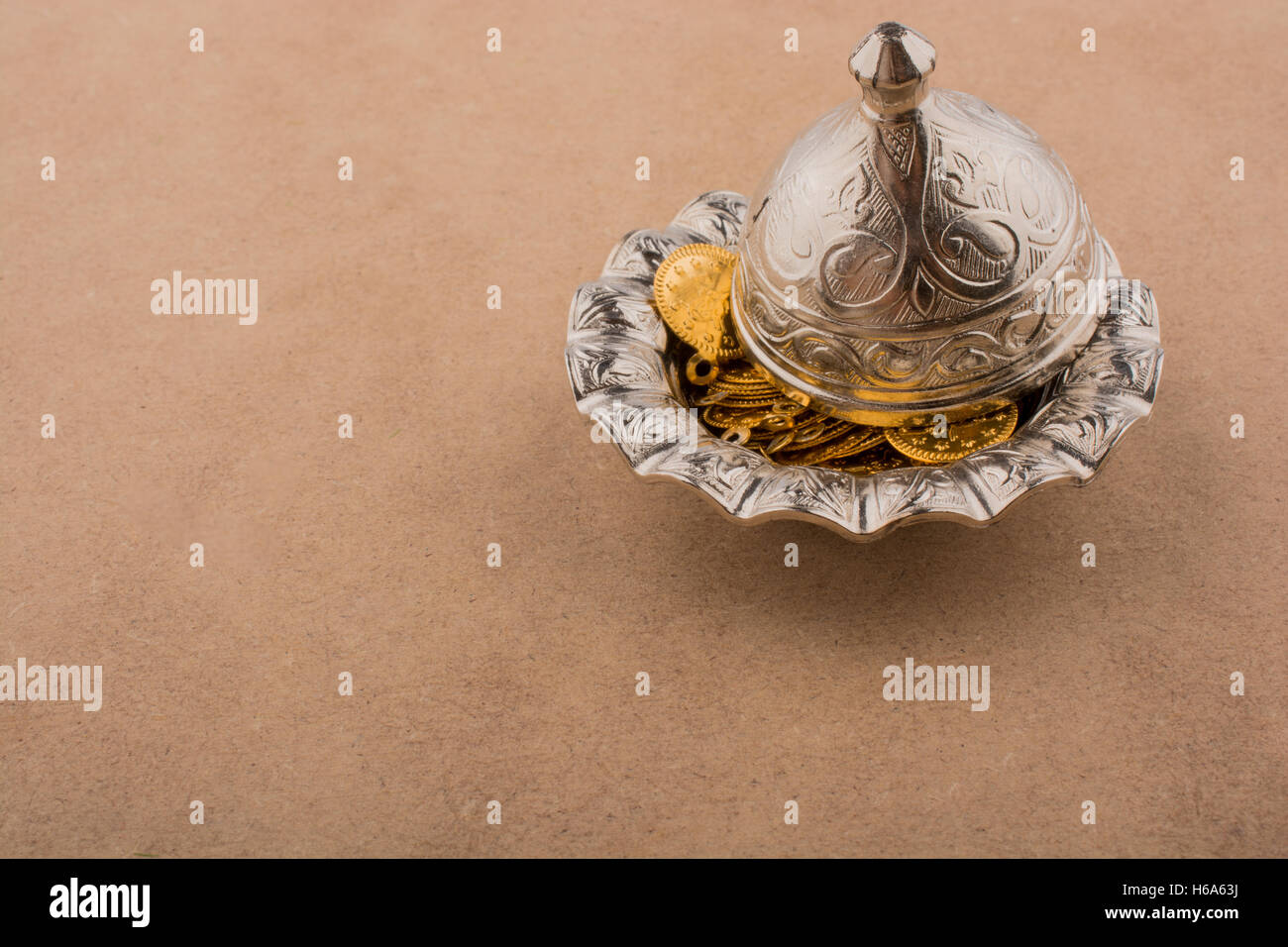 Fake gold coins in an old decorative metal plate Stock Photo - Alamy