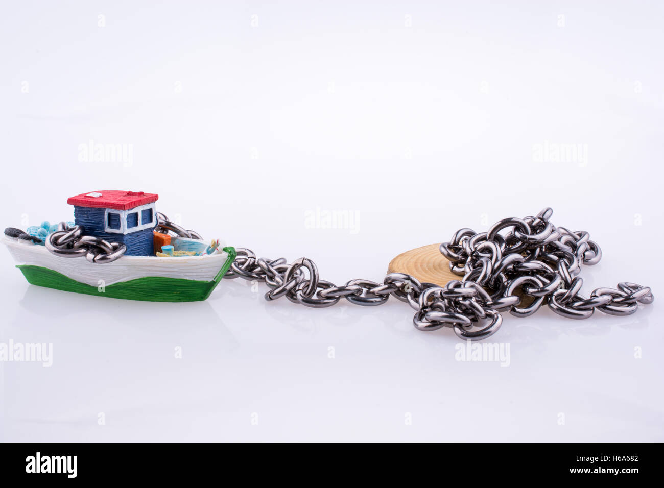 Little colorful model boat with chains on white background Stock Photo ...