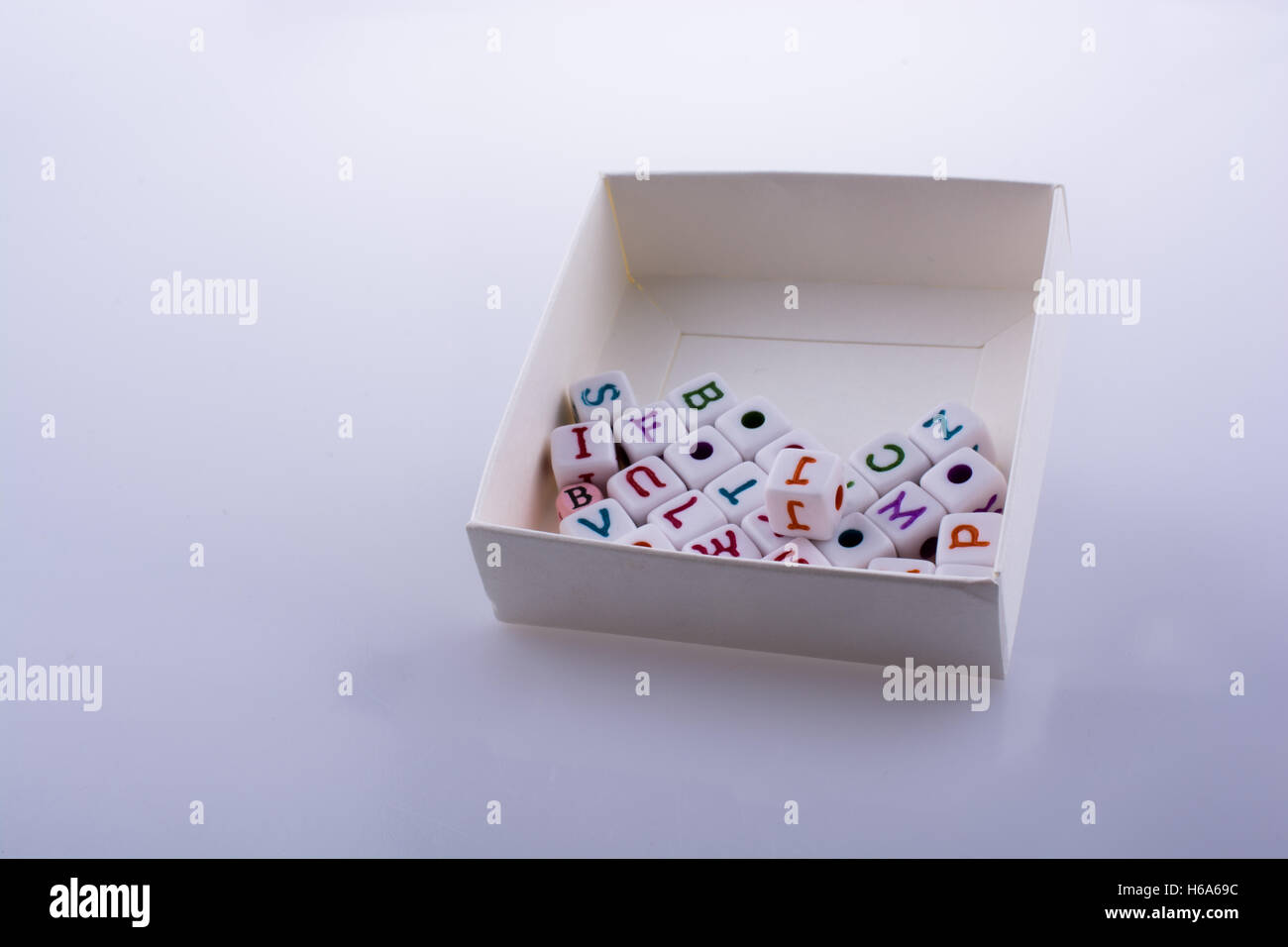 Colorful alphabet letter cubes in a box on a white background Stock ...