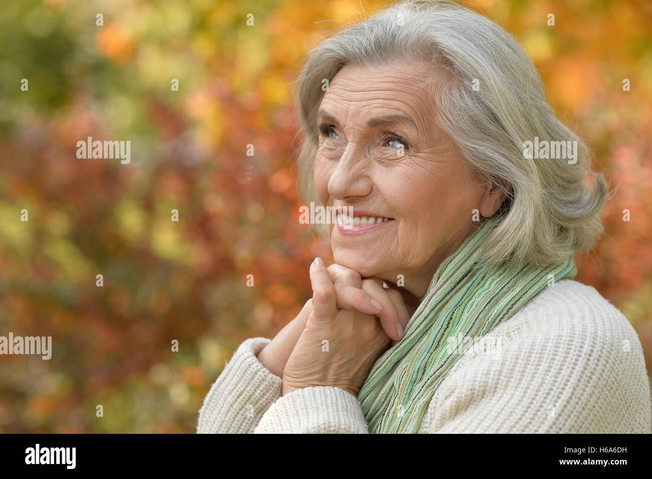 Beautiful middle-aged woman in autumn park Stock Photo - Alamy