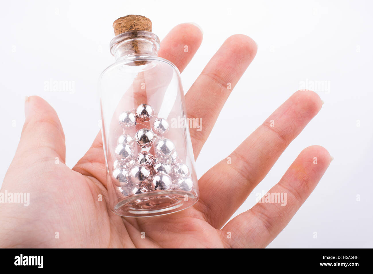 Little perfume glass bottle in hand on a white background Stock Photo ...