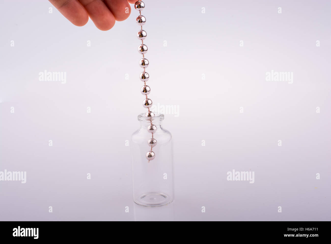 Little perfume glass bottle in hand on a white background Stock Photo ...