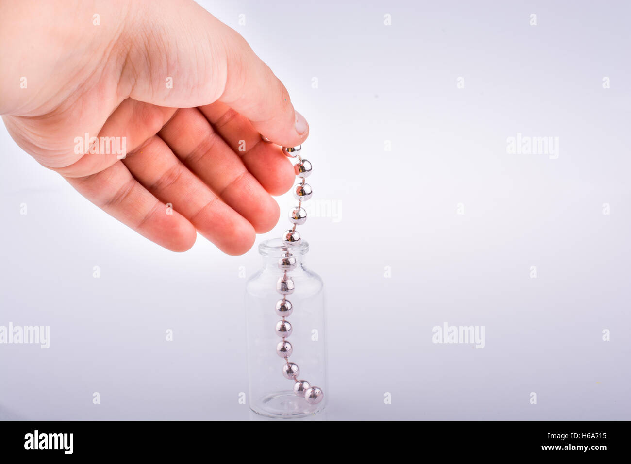 Little perfume glass bottle in hand on a white background Stock Photo ...