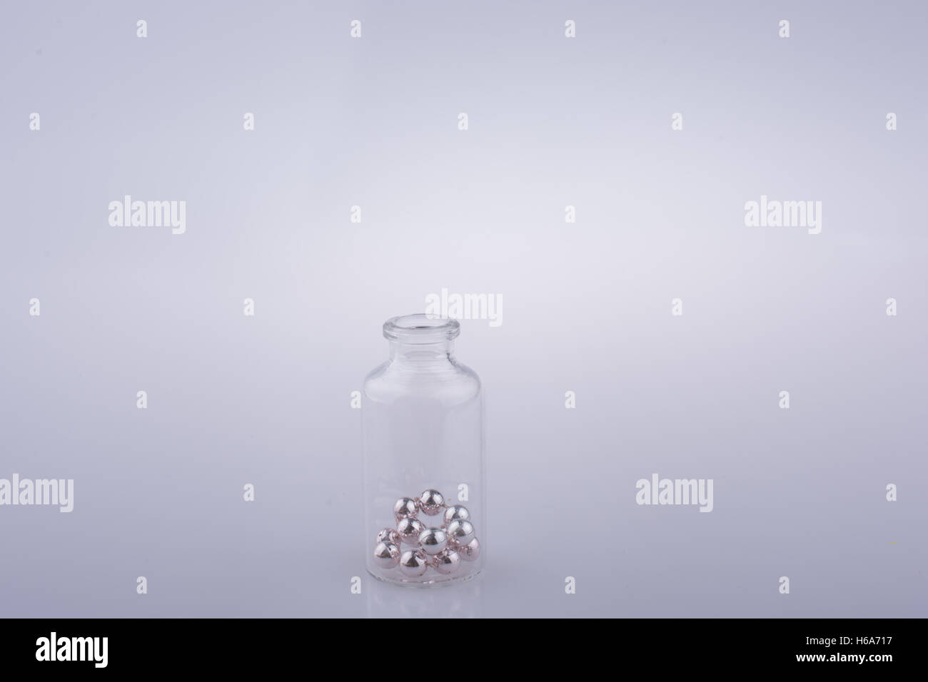 Little perfume glass bottle in hand on a white background Stock Photo ...