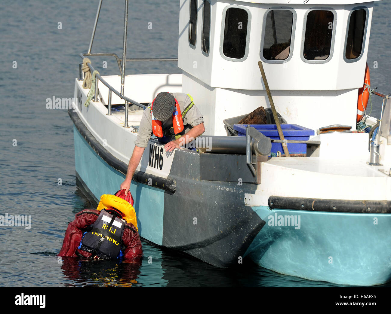 Fishermen practice a man overboard rescue exercise, Weymouth, Dorset ...