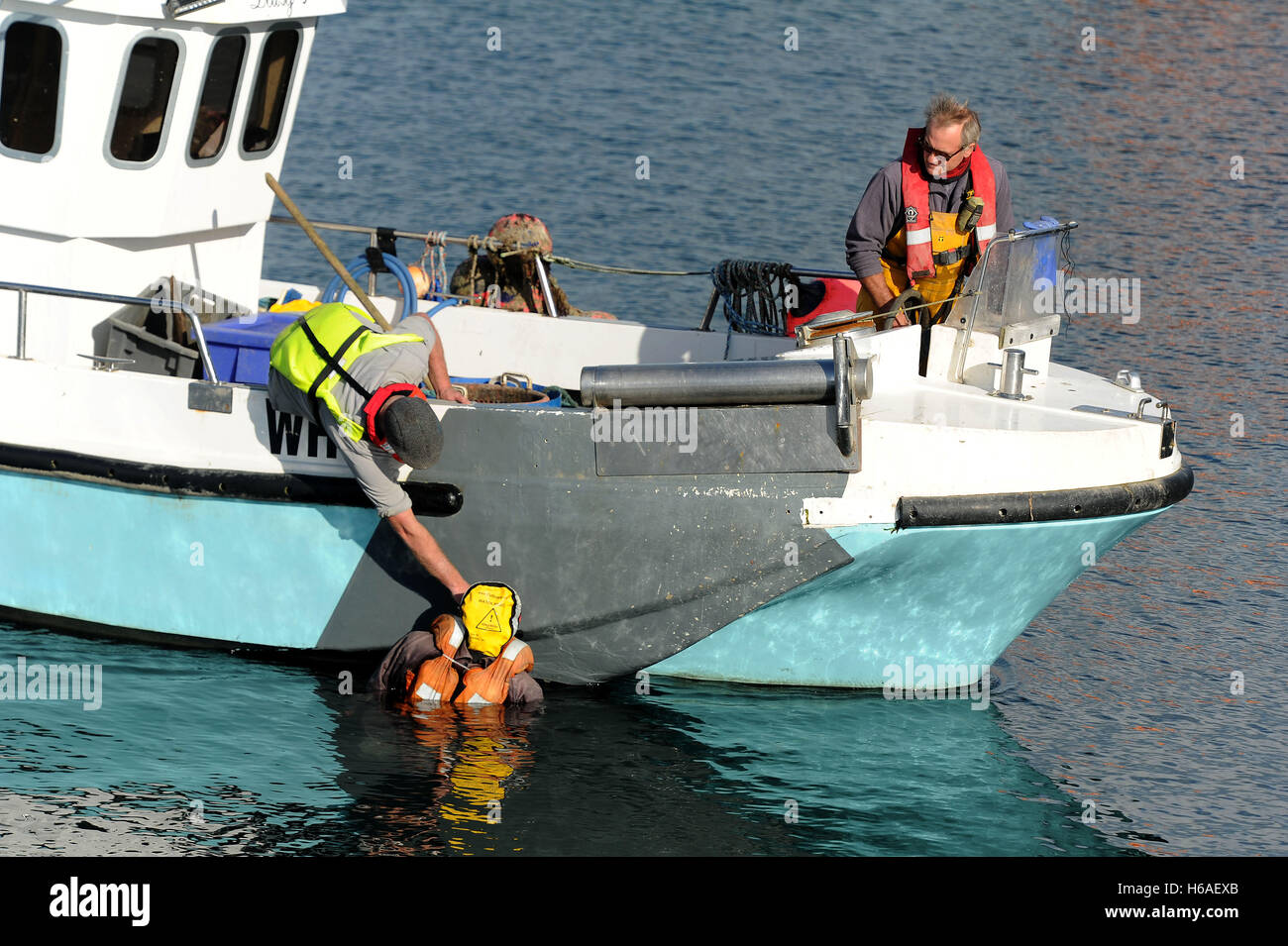 Fishermen practice a man overboard rescue exercise, Weymouth, Dorset ...