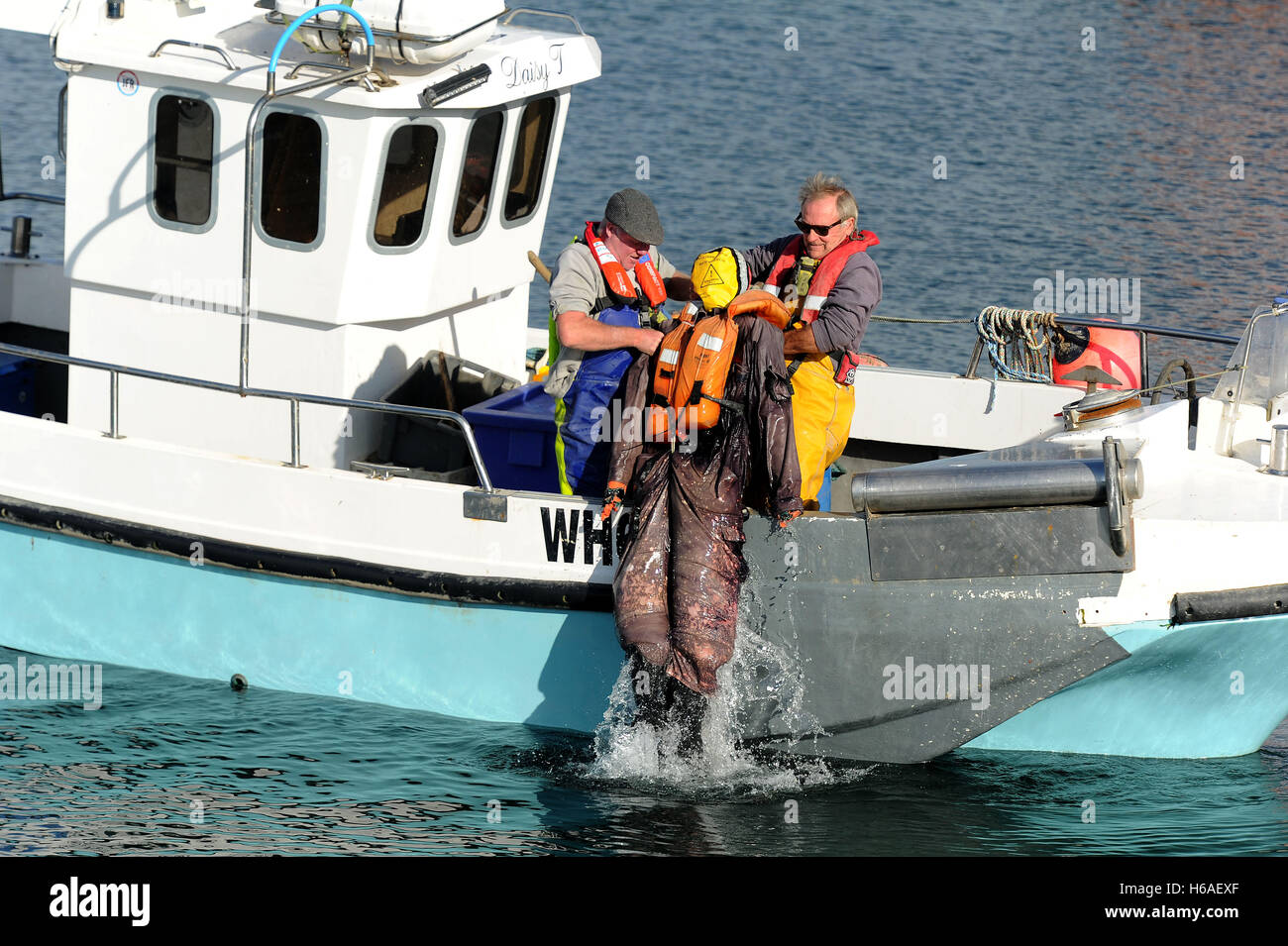 Fishermen practice a man overboard rescue exercise, Weymouth, Dorset ...