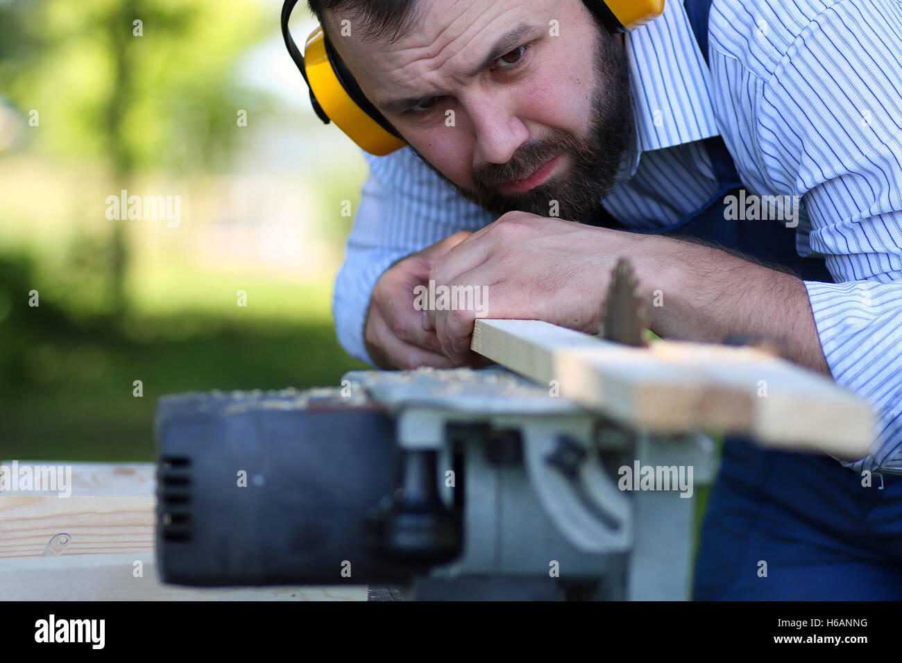 beard man working on Circular saw Stock Photo - Alamy