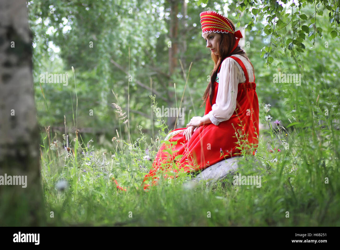Slav in traditional dress is sitting in nature Stock Photo - Alamy
