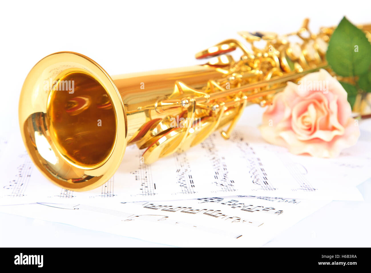 Pink rose, saxophone and music sheet on a white background Stock Photo ...