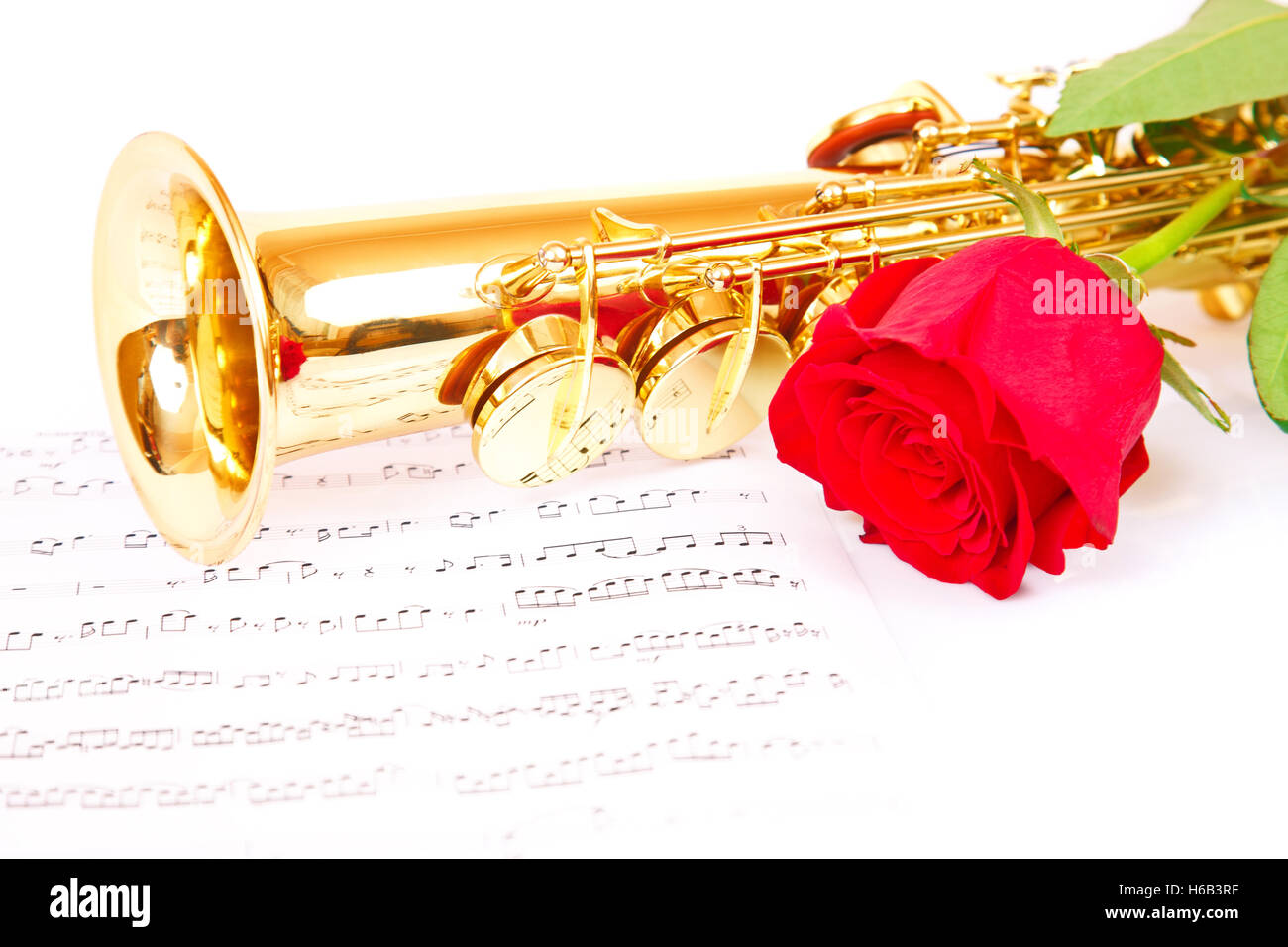 Pink rose, saxophone and music sheet on a white background Stock Photo ...