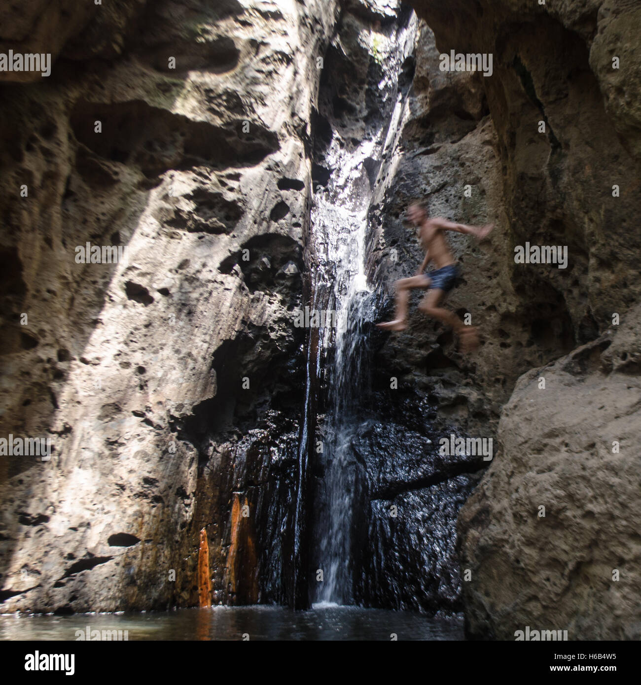 Cliff jumping into a canyon made by a waterfall Stock Photo - Alamy