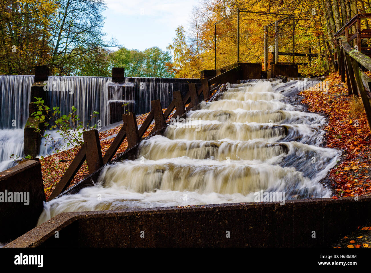 Fish ladder with rapids in fall woodland landscape. Overflow of water ...