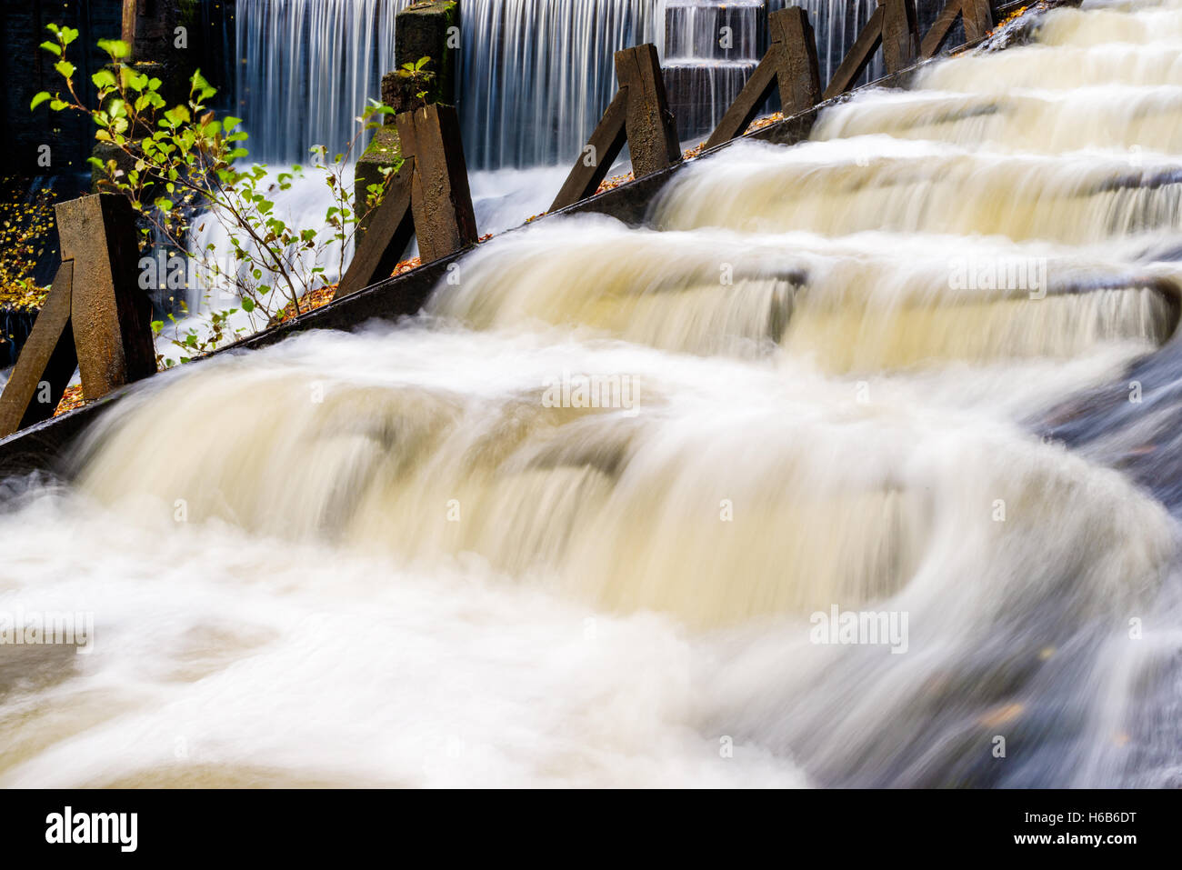Fish ladder with rapids in fall. Water flowing in steps is helpful for ...