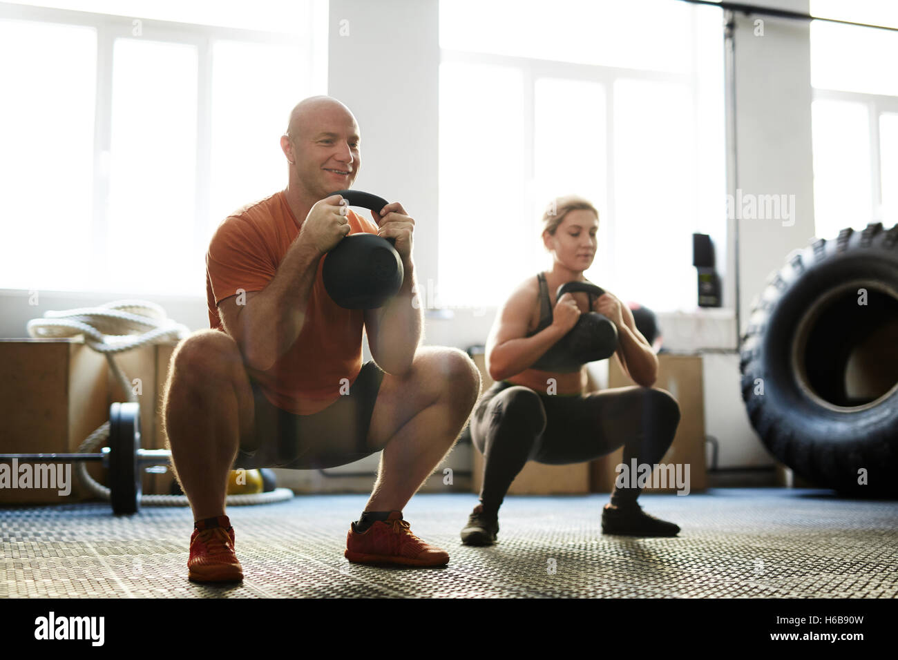 Exercise on squats Stock Photo - Alamy