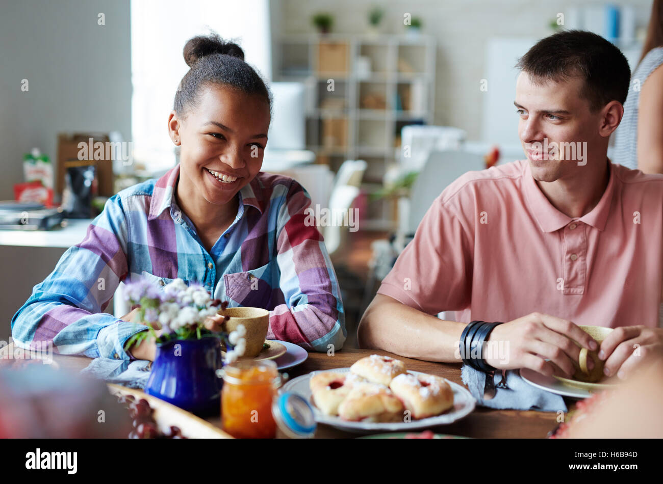 Friends by table Stock Photo - Alamy