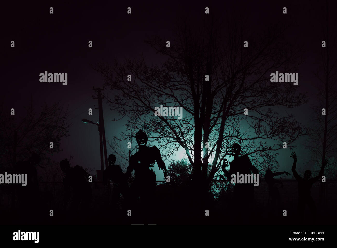 crowd of hungry zombies in the woods. Silhouettes of scary zombies ...