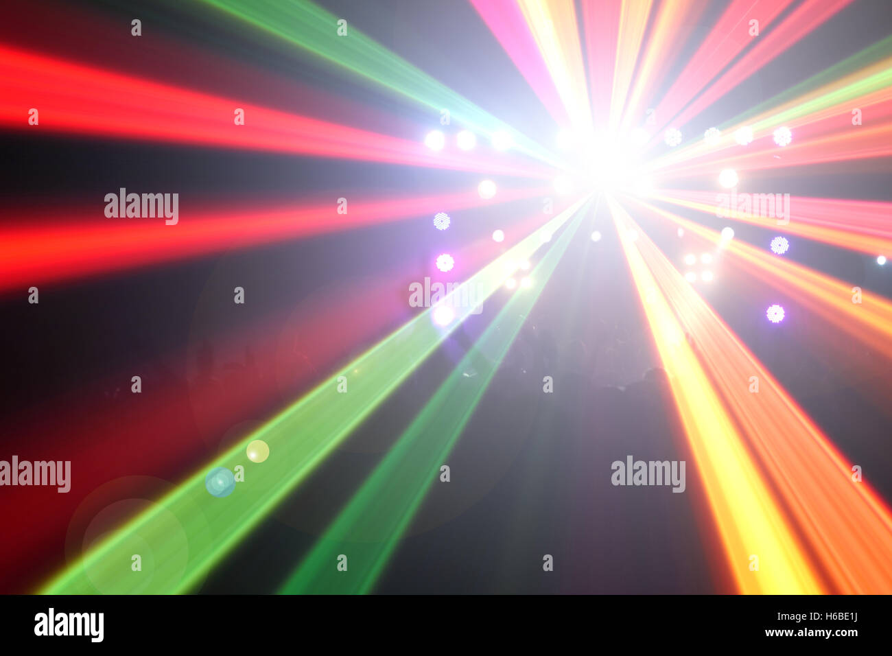 Colorful laser effects over the audience at a concert from the view of ...