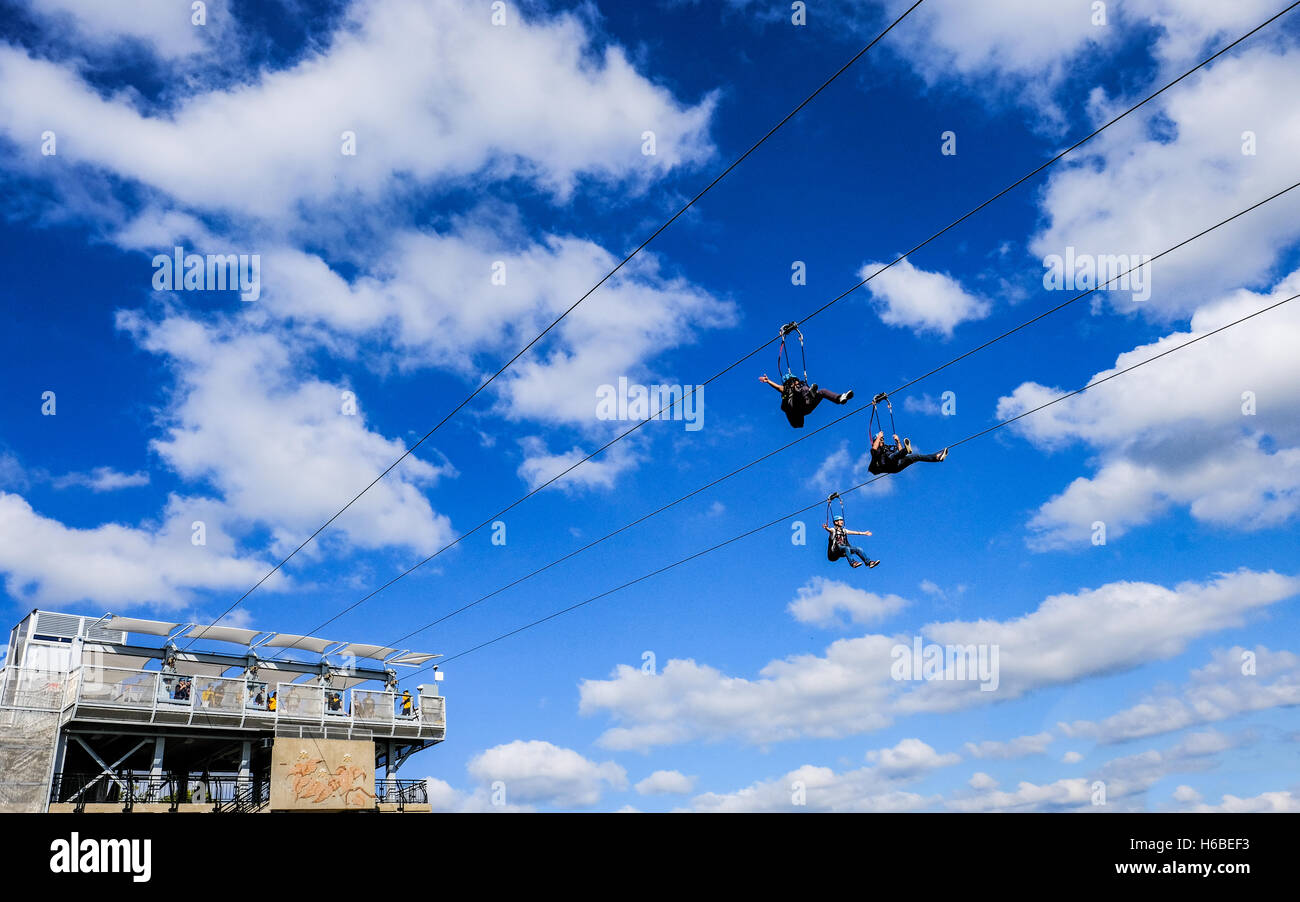Teenagers having fun on a zip wire Stock Photo - Alamy