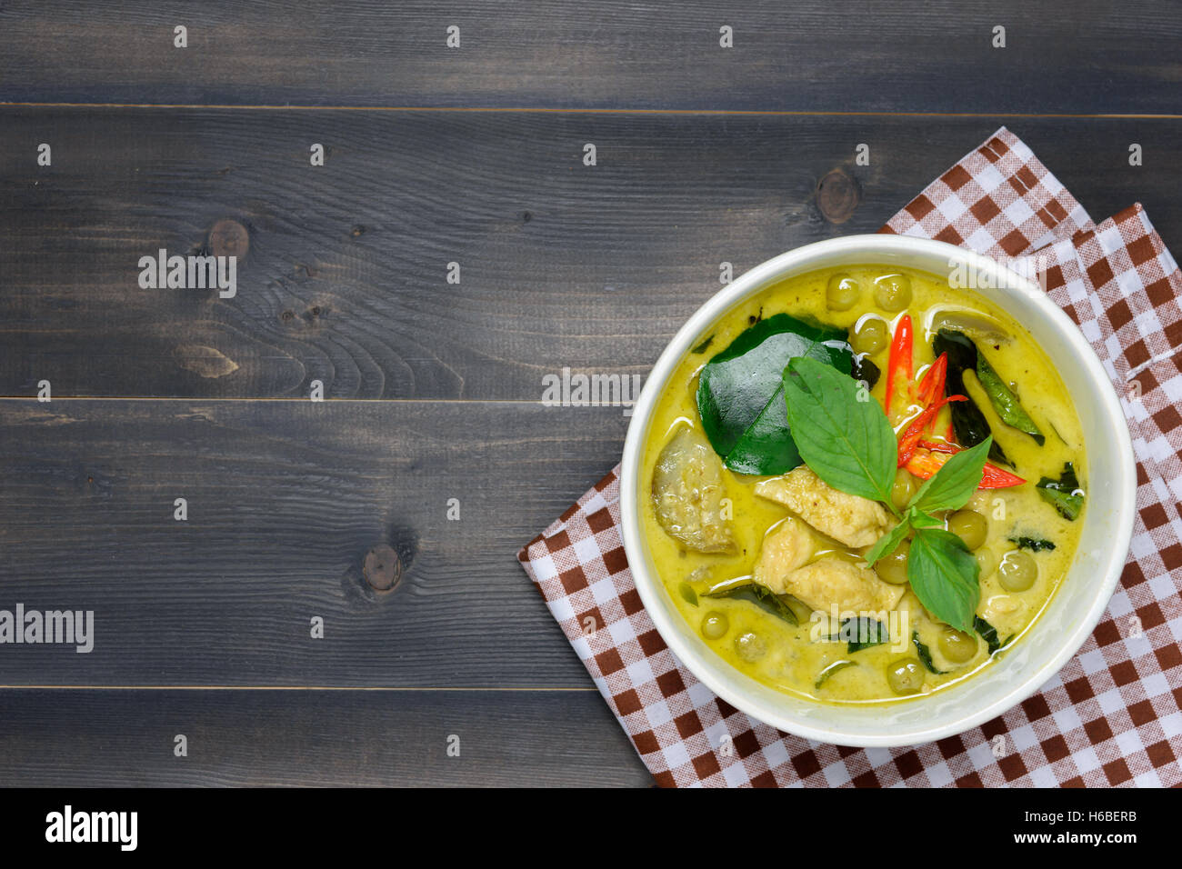 green curry with chicken (Kang Keaw Wan Gai) with brown tablecloth on ...
