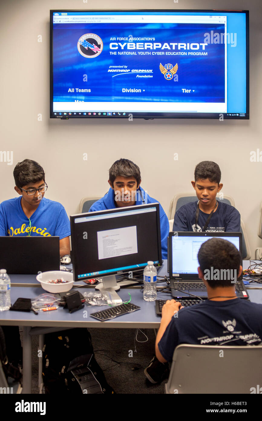 Enthusiastic multiracial teen boys compete in the CyberPatriot Cyber ...