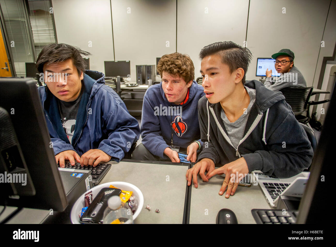 Enthusiastic multiracial teen boys compete in the CyberPatriot Cyber ...