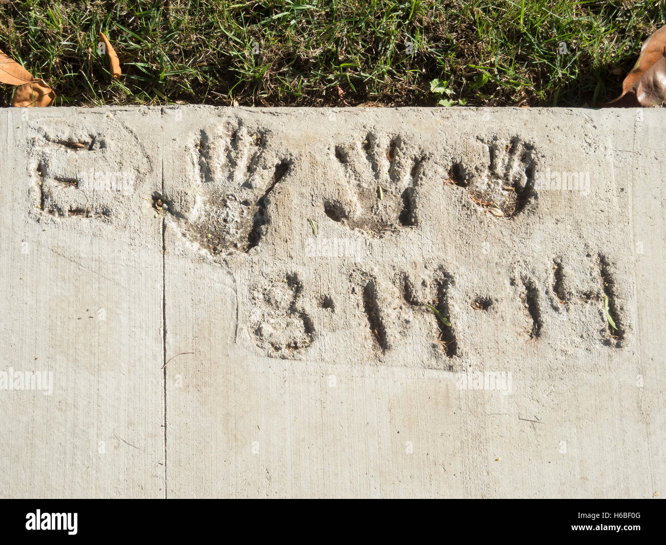 Hand impressions of people of two generations with a date and an ...