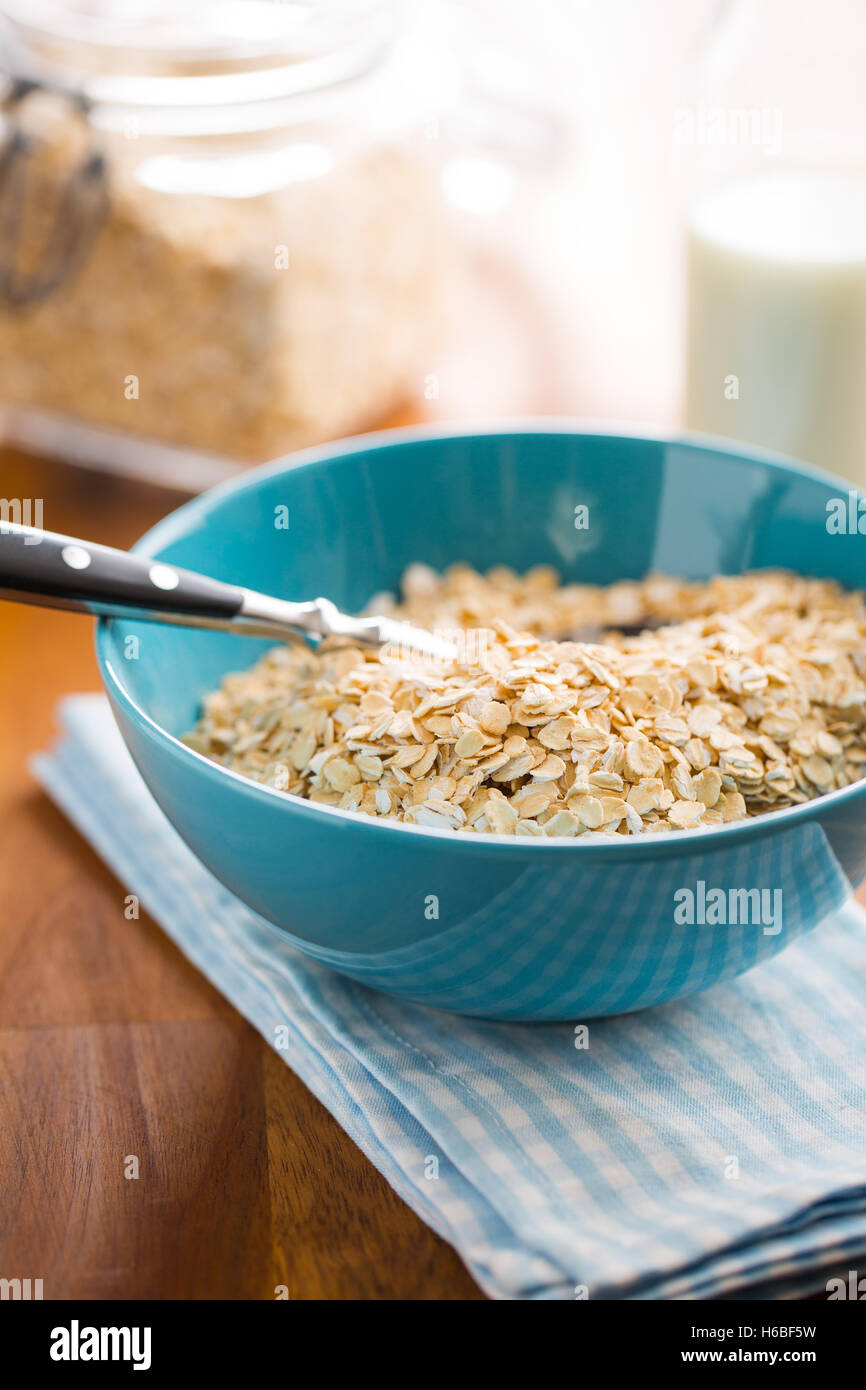 Dry rolled oatmeal in blue bowl Stock Photo - Alamy