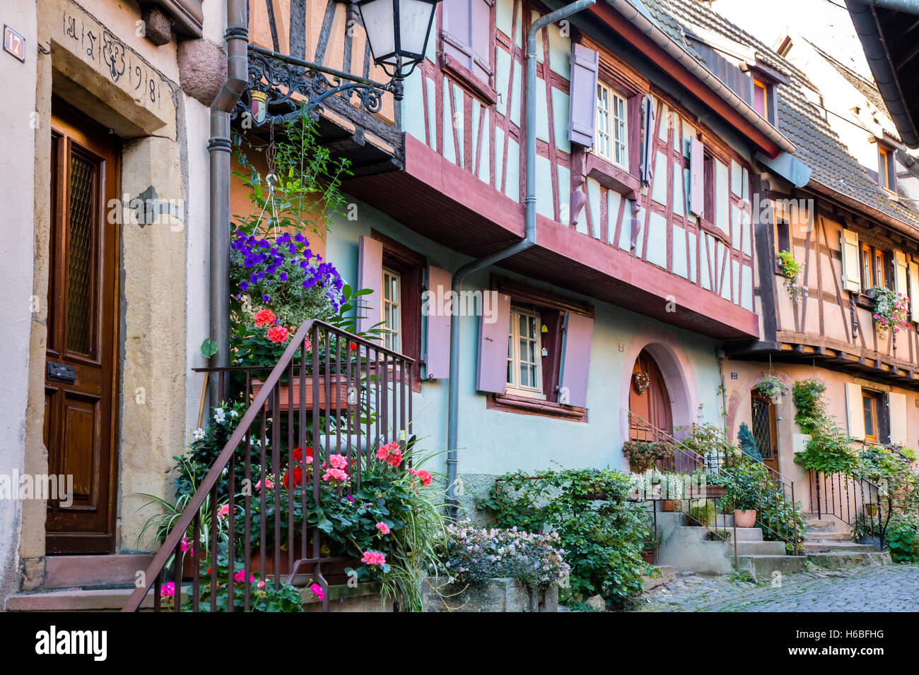 Colourful half-timbered traditional house in Eguisheim wine route ...