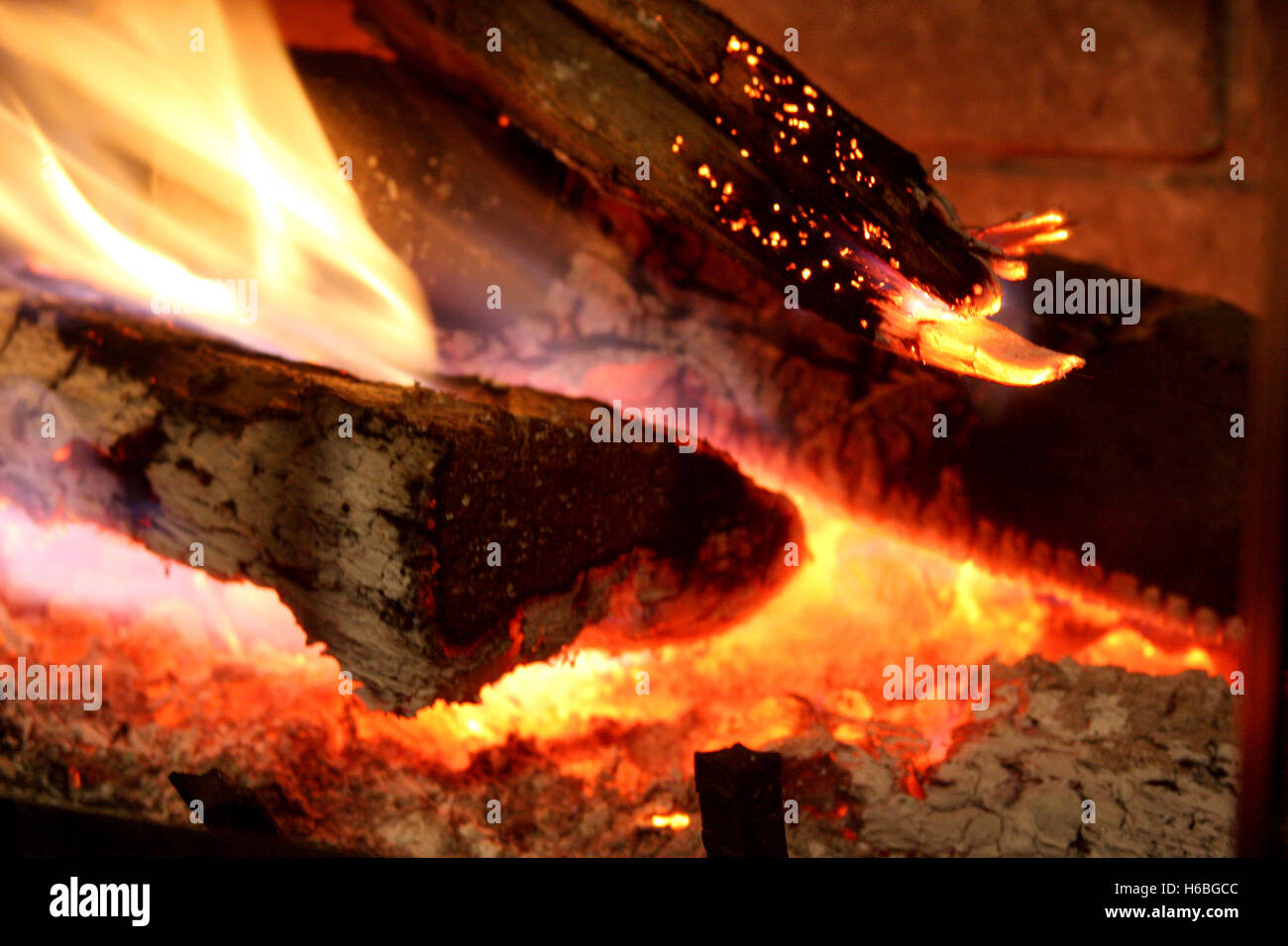 Close-up of burning logs and ashes in fireplace Stock Photo - Alamy
