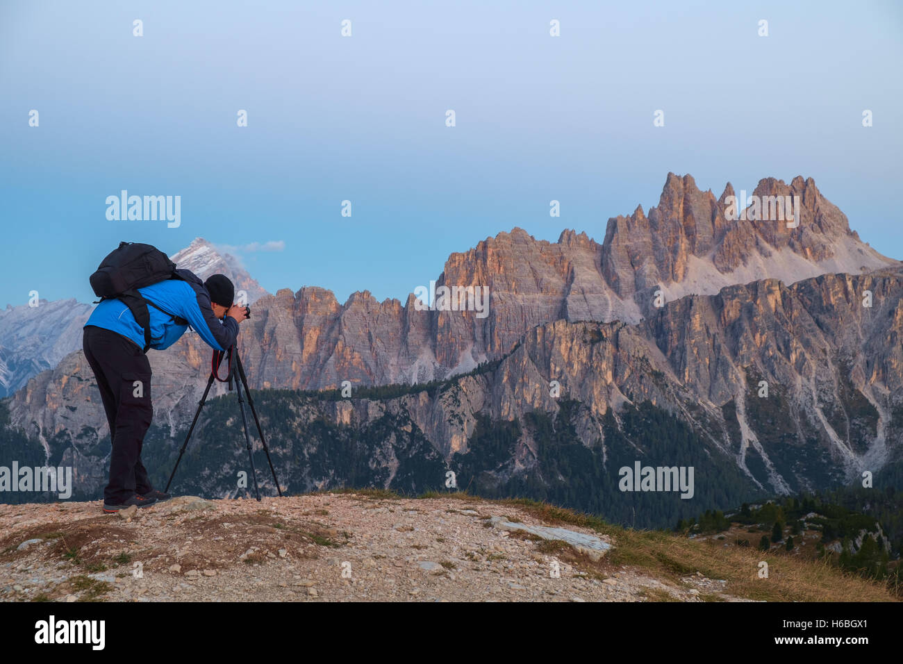 Photographer taking a picture the sunset over the Dolomites Alps-Italy ...