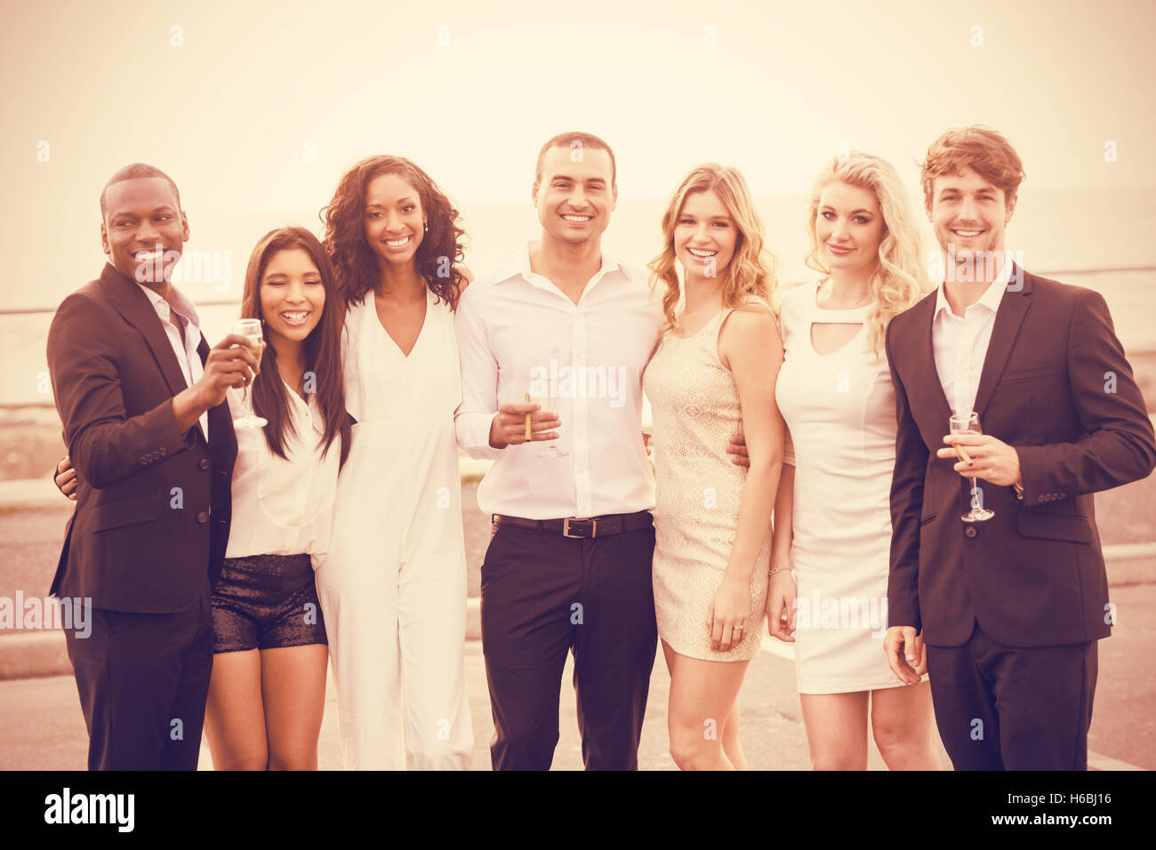 Portrait of well dressed people posing next to limousine Stock Photo ...