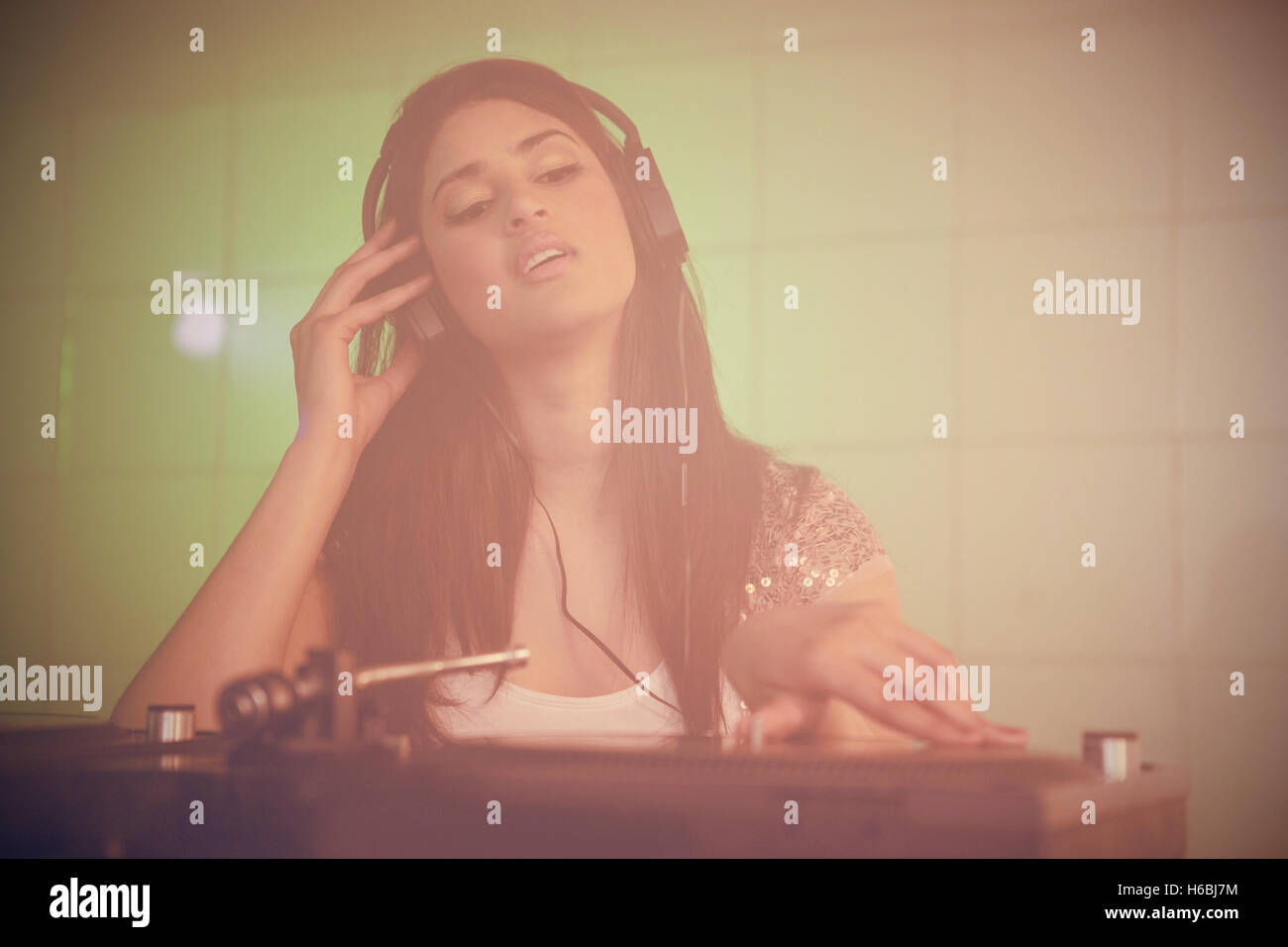 Pretty female DJ playing music Stock Photo - Alamy