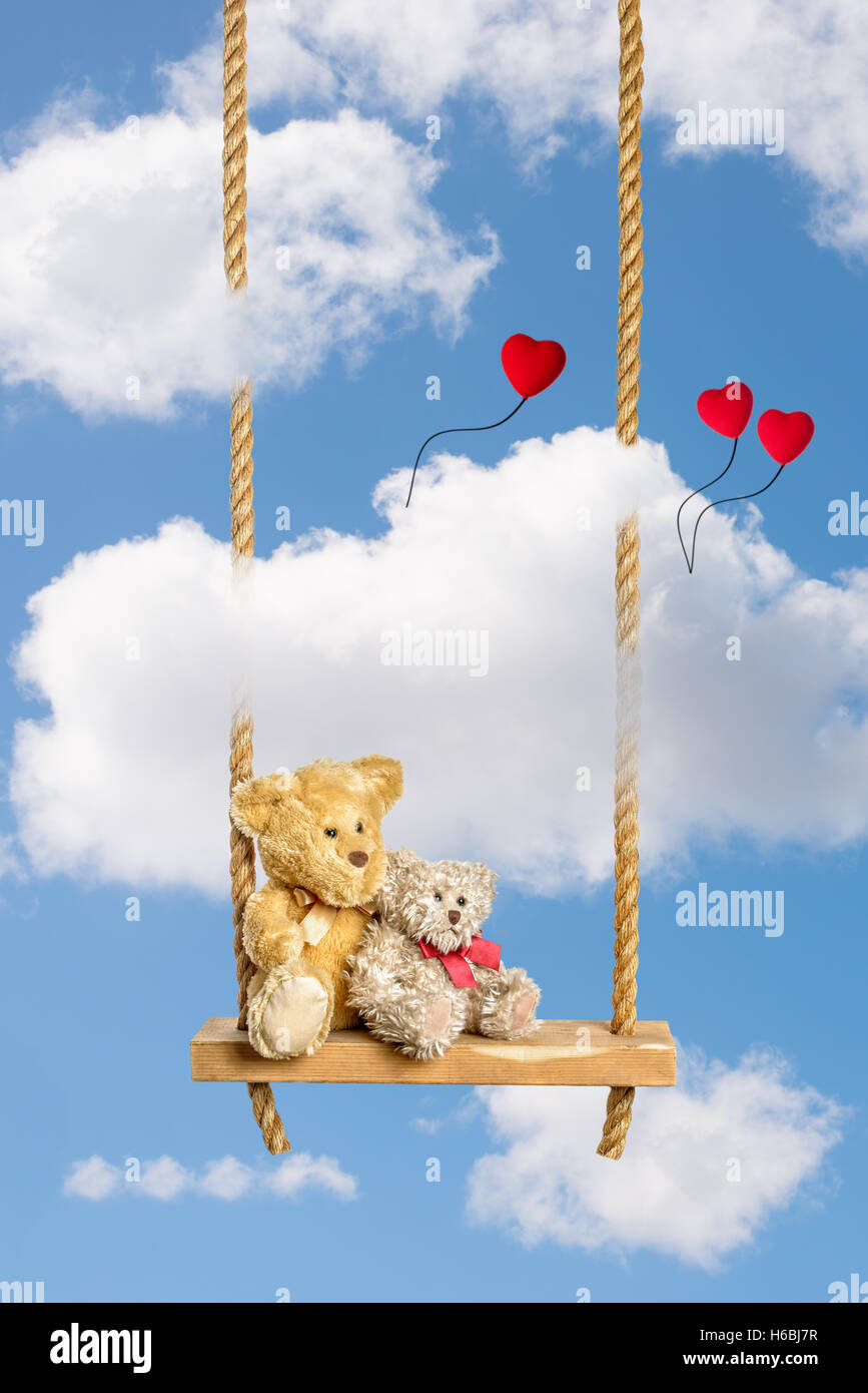 Two teddie bears sitting on rustic wooden rope swing Stock Photo - Alamy