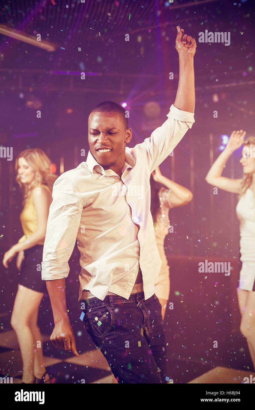 Composite image of happy friends dancing cheerfully Stock Photo - Alamy