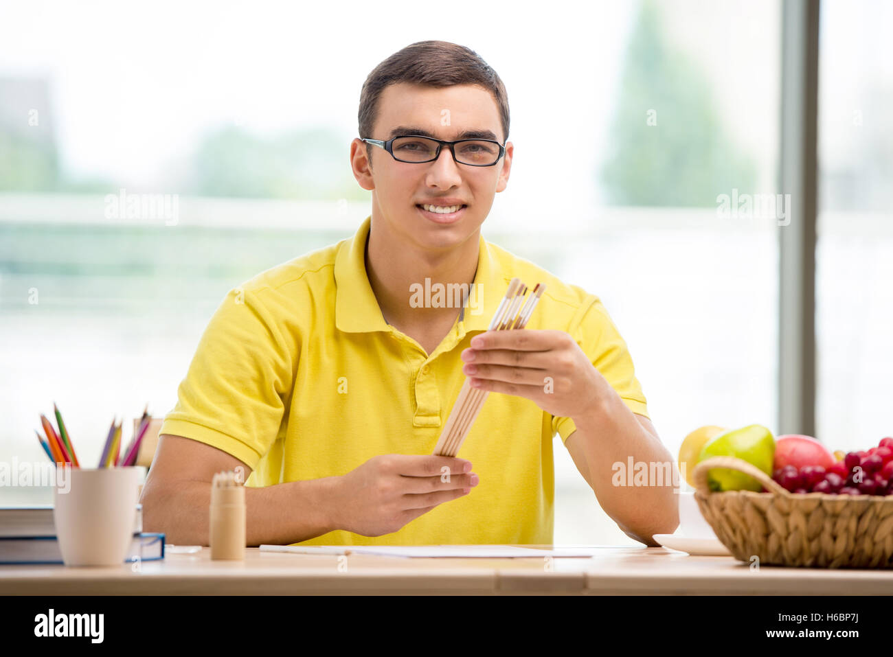 Young man drawing pictures in studio Stock Photo - Alamy