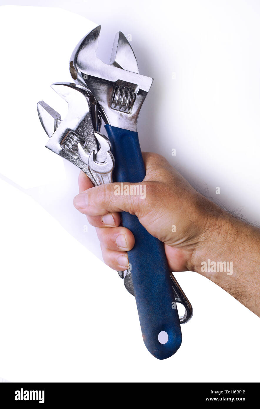 Front view of strong man hand holding tightly a set of working tools ...