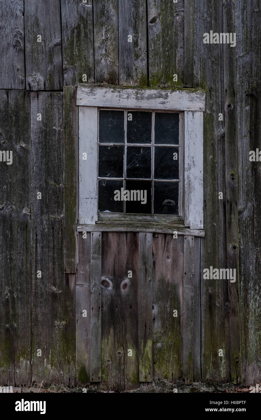 A broken window on an old wooden barn Stock Photo - Alamy