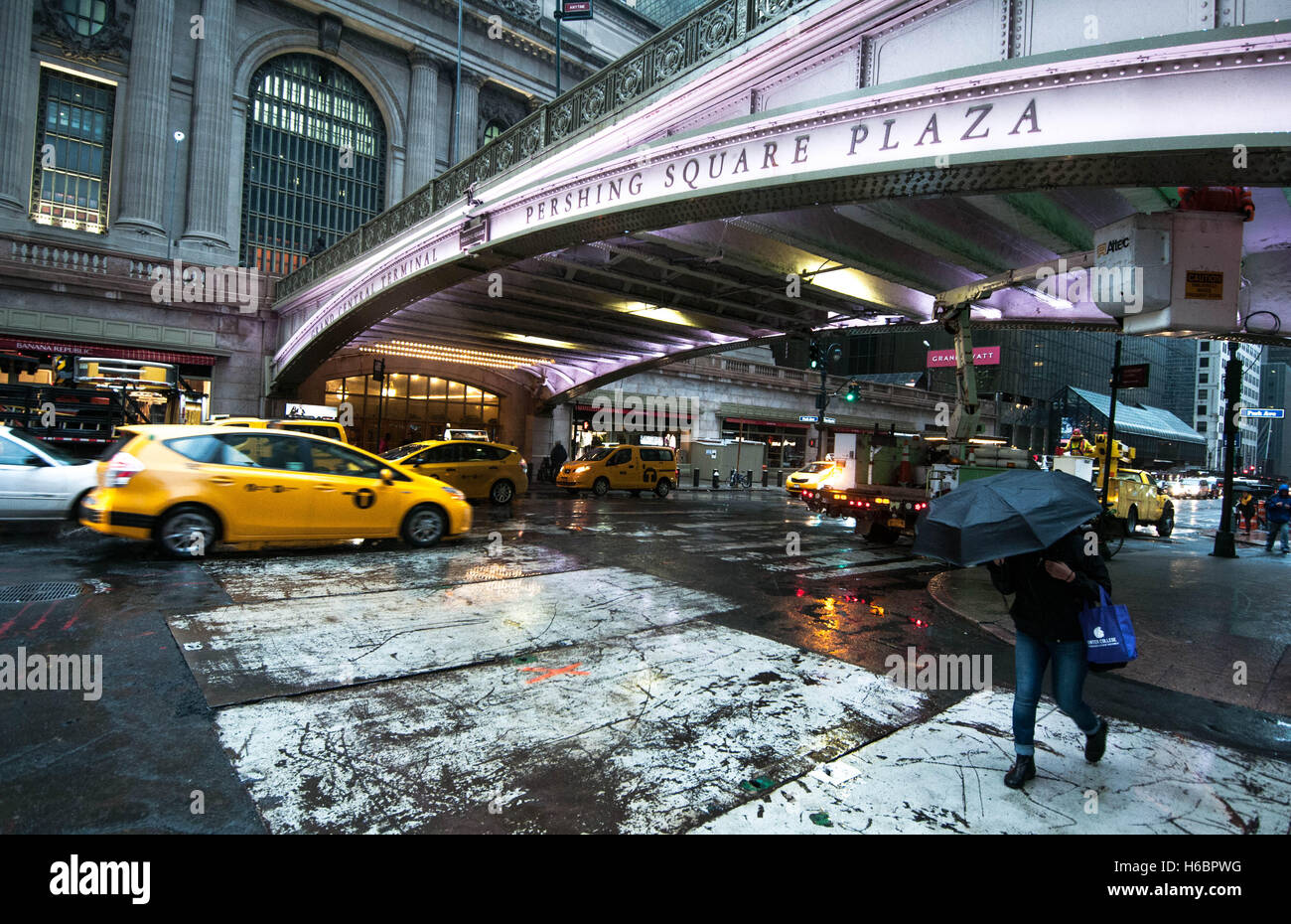 A pedestrian and taxis under the Pershing Square Plaza bridge at Grand ...