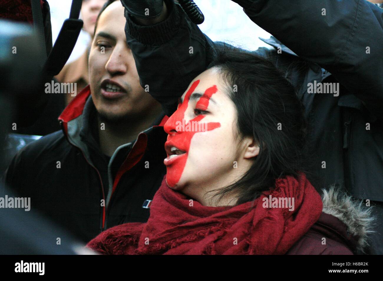 A protester paints her face with a red hand to symbolise those who have ...