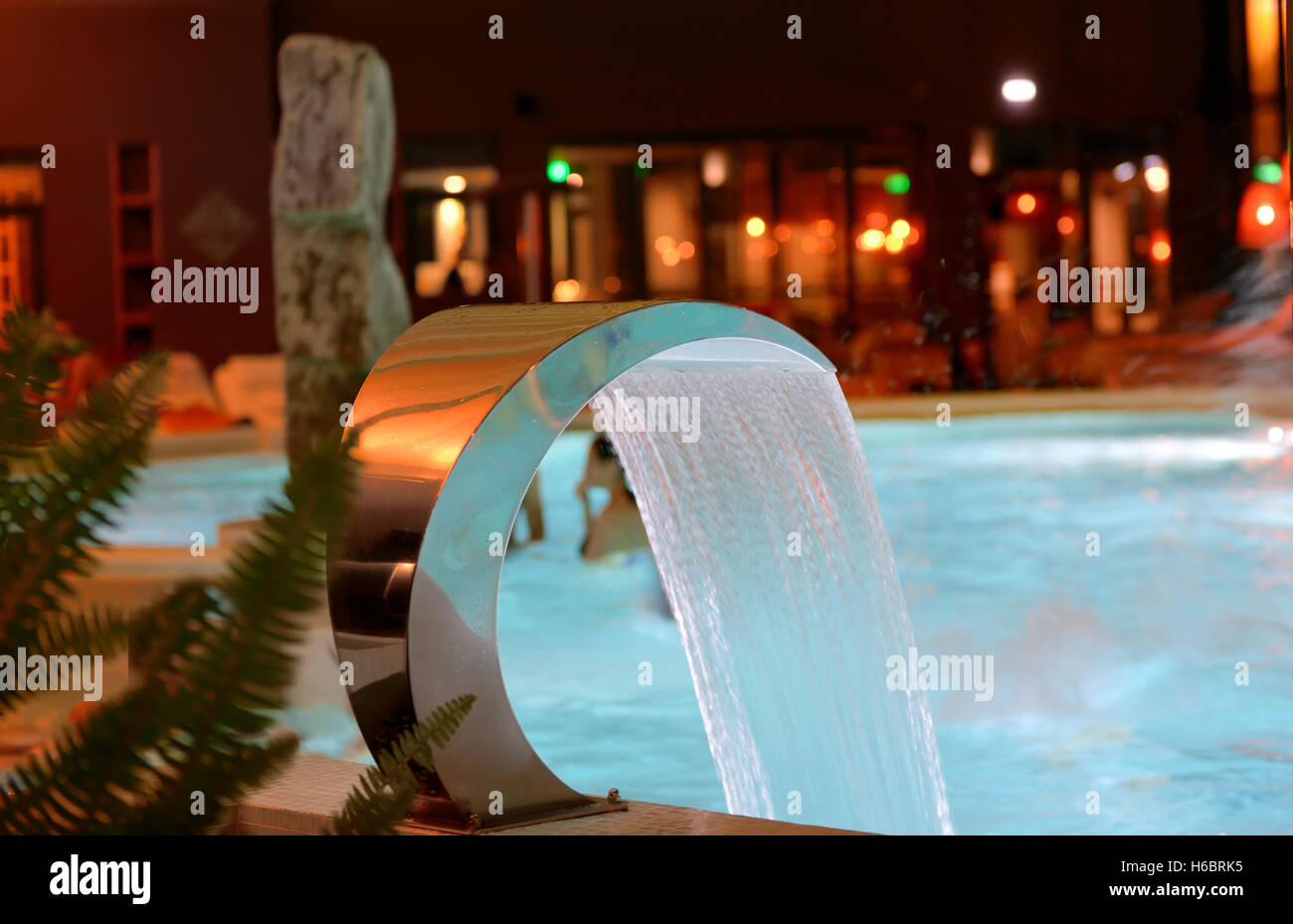 Relaxation pool in spa with waterfall Stock Photo - Alamy