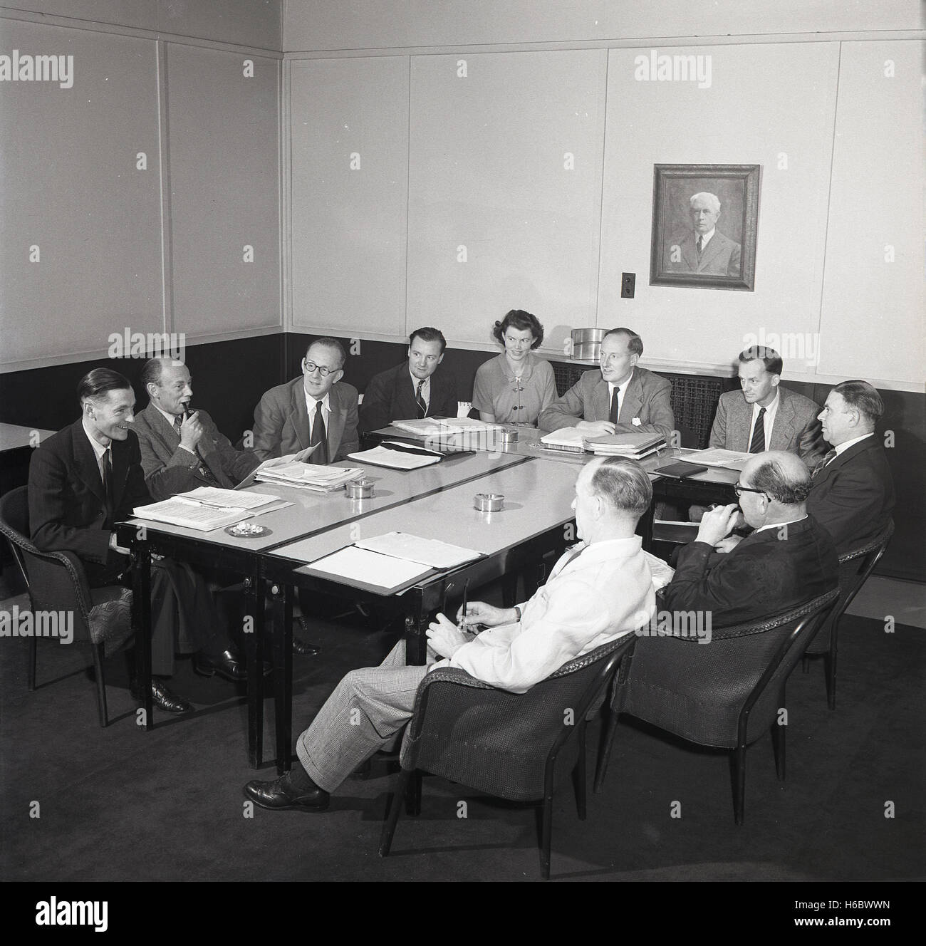 1950s, historical, Company managers and Directors with paperwork sit ...