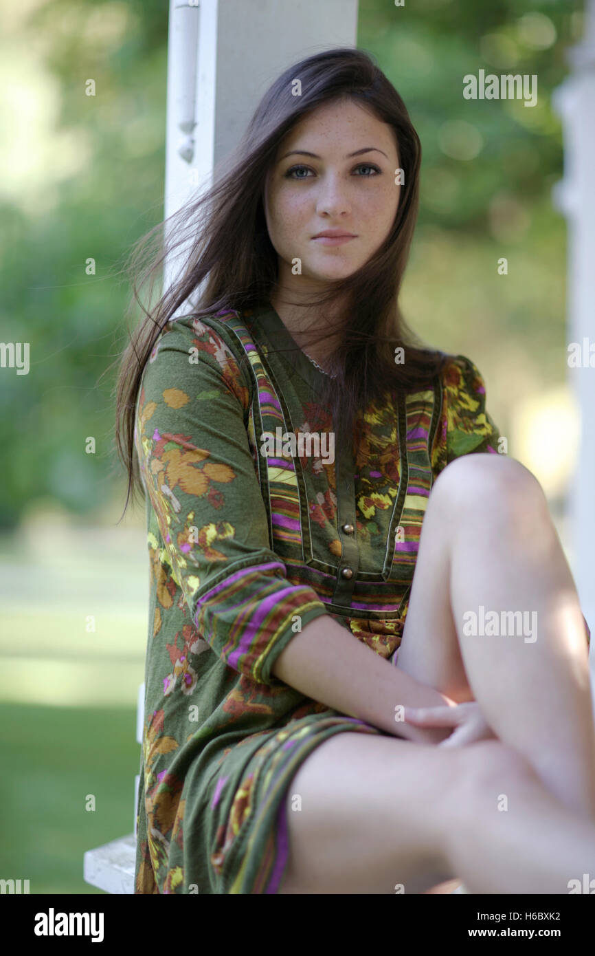 Young woman, sitting Stock Photo - Alamy