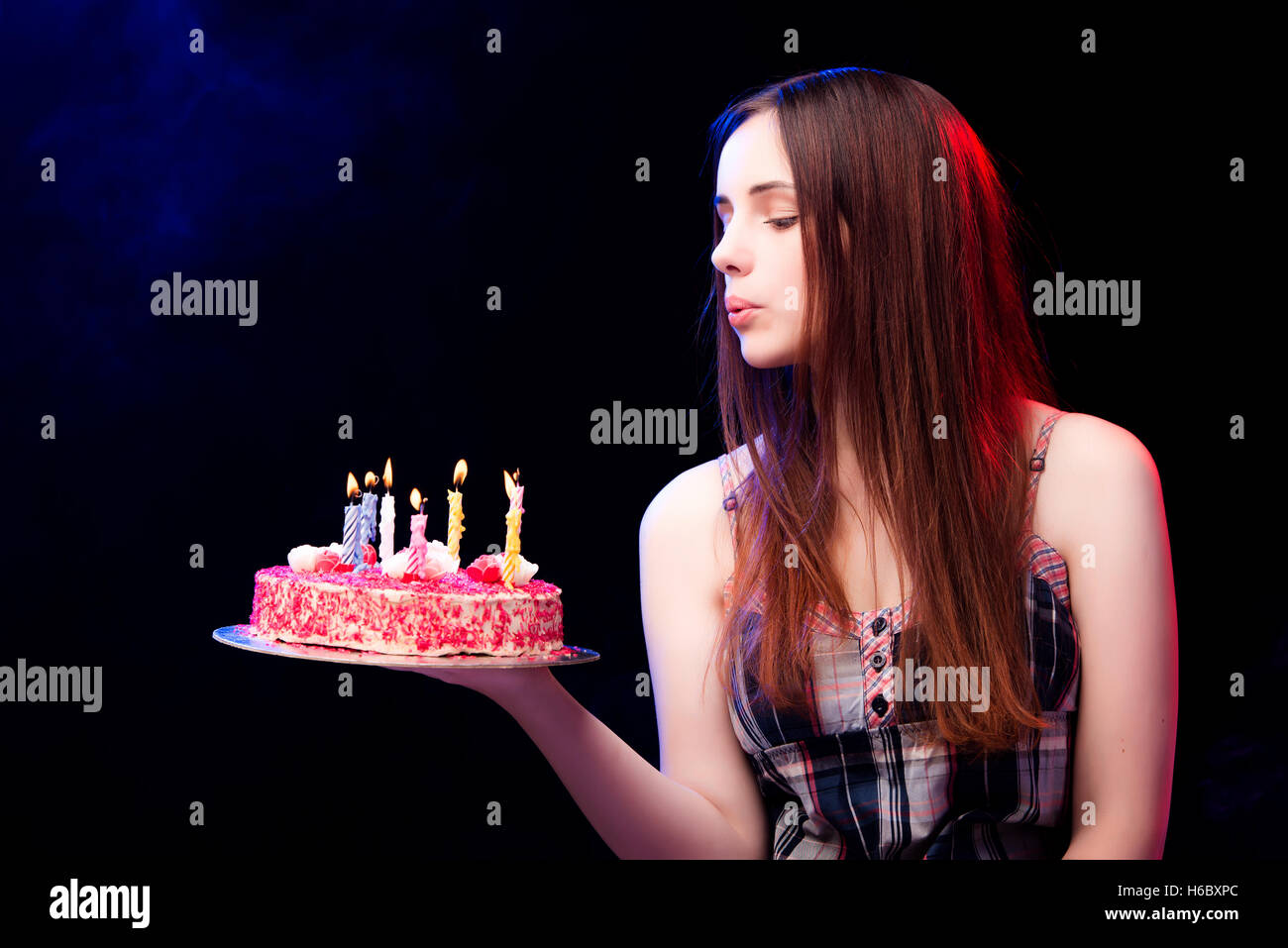 Young woman with birthday cake at party Stock Photo - Alamy