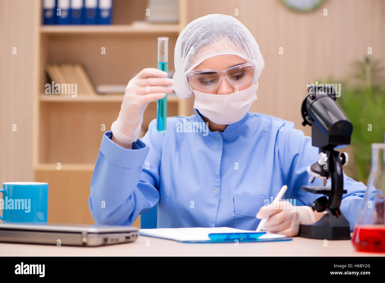 Lab chemist working with microscope and tubes Stock Photo - Alamy